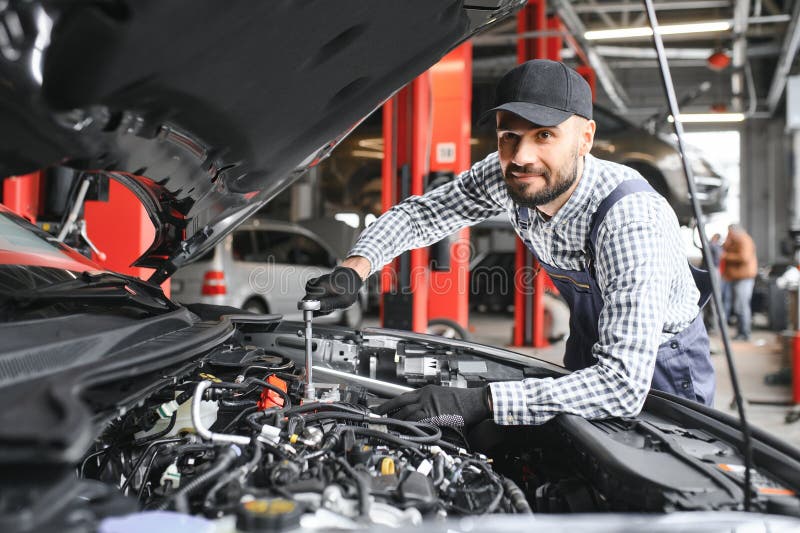 Handsome Car Mechanic is Posing in a Car Service. Stock Image - Image ...