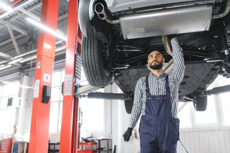 Handsome Car Mechanic is Posing in a Car Service. Stock Photo - Image ...