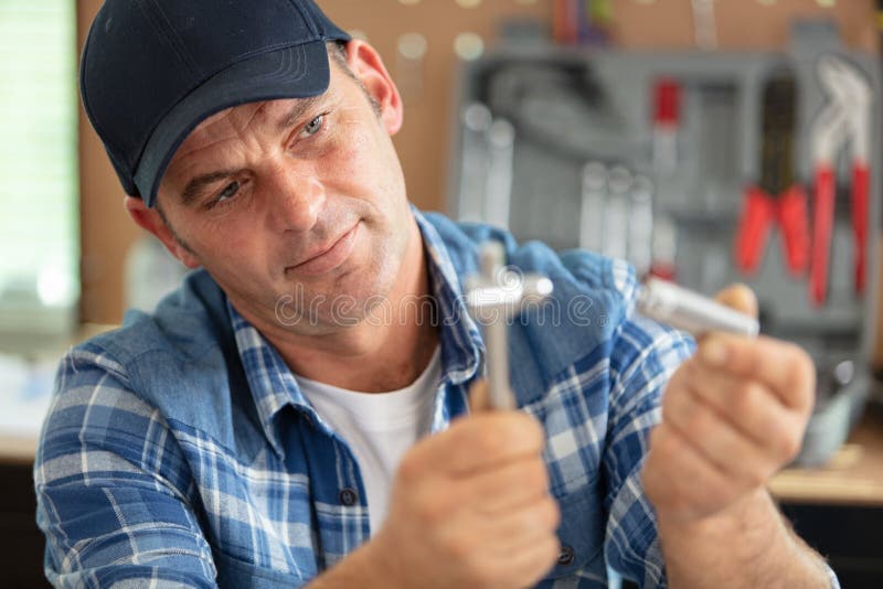 Handsome Carpenter In Uniform Standing In Workshop Stock Image - Image ...