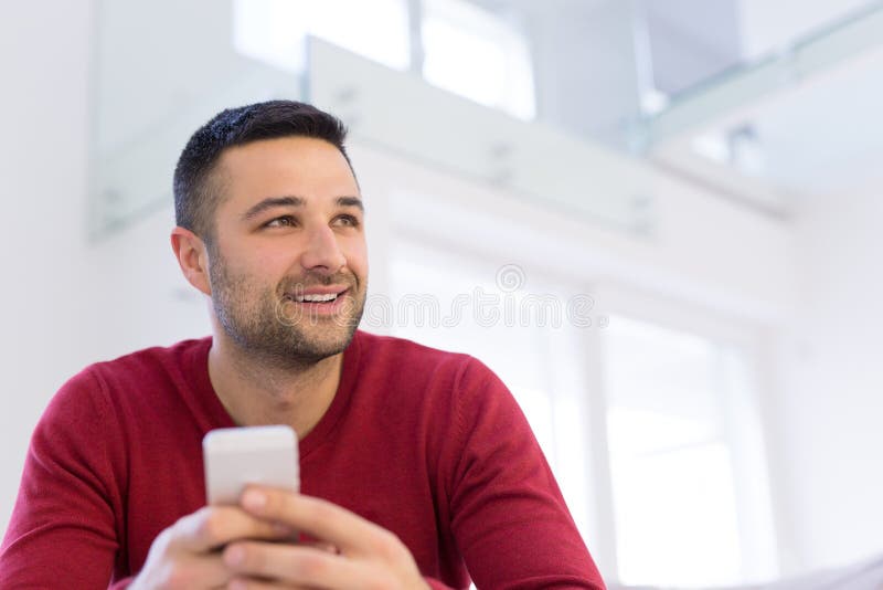 Young Man Using a Mobile Phone at Home Stock Photo - Image of internet ...