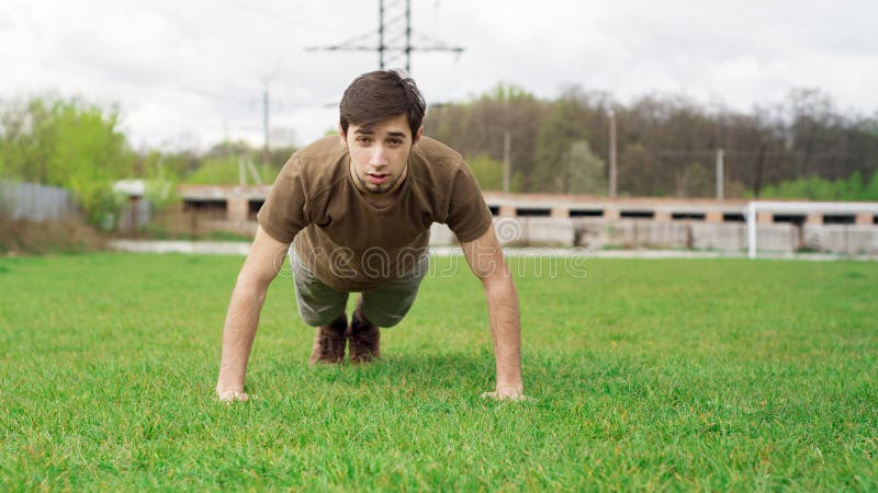Handsome Guy Doing Physical Exercises in the Stadium Stock Photo ...