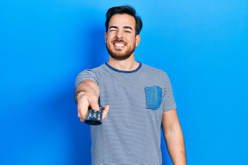 Handsome Caucasian Man with Beard Holding Television Remote Control ...