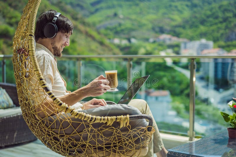 Handsome Caucasian Man Sitting on the Terrace Working from Home Using ...