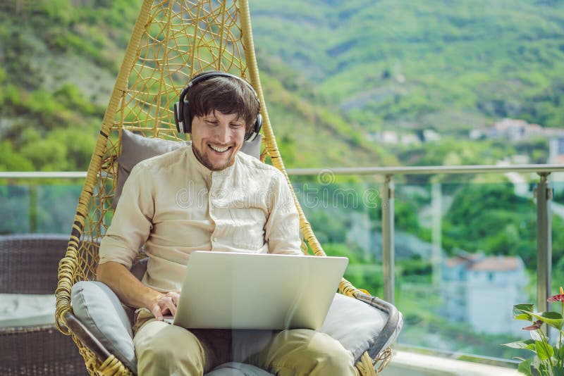 Handsome Caucasian Man Sitting on the Terrace Working from Home Using ...