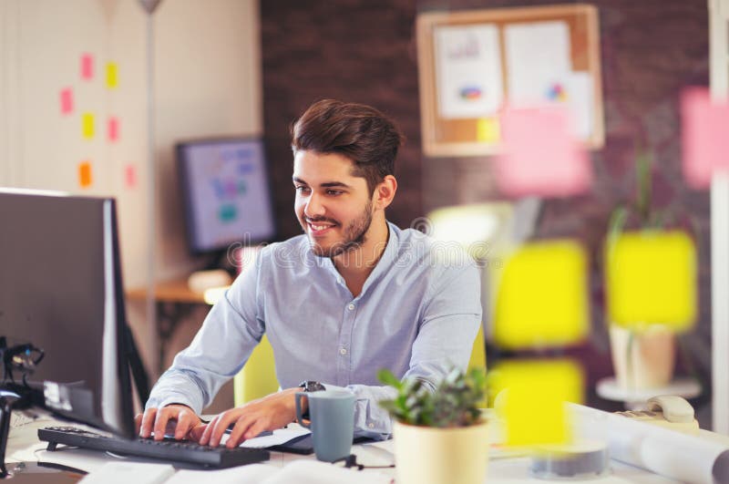 Handsome Caucasian Man at Work Desk Facing Flat Screen Computer Stock ...
