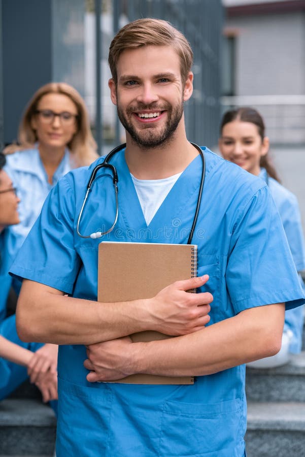 Handsome Caucasian Medical Student Standing with Notebook and Looking ...