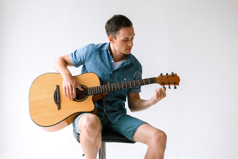 Handsome and Cheerful Guy Musician in a Shirt Playing Guitar Stock ...