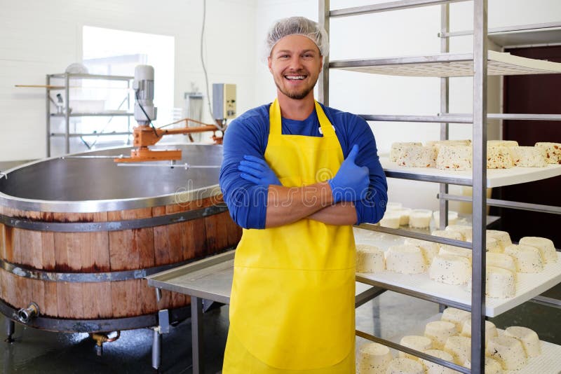 Handsome Cheesemaker Making Curd Cheese in His Factory. Stock Image ...