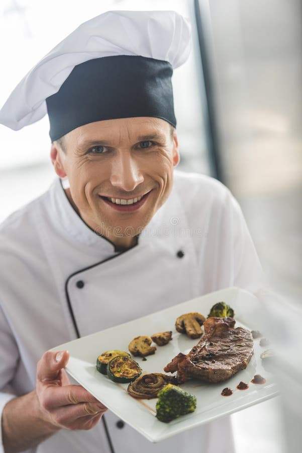 Handsome Chef Holding Plate with Cooked Steak Stock Photo - Image of ...