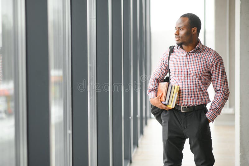 Handsome College Boy Holding Books on Campus Stock Image - Image of ...