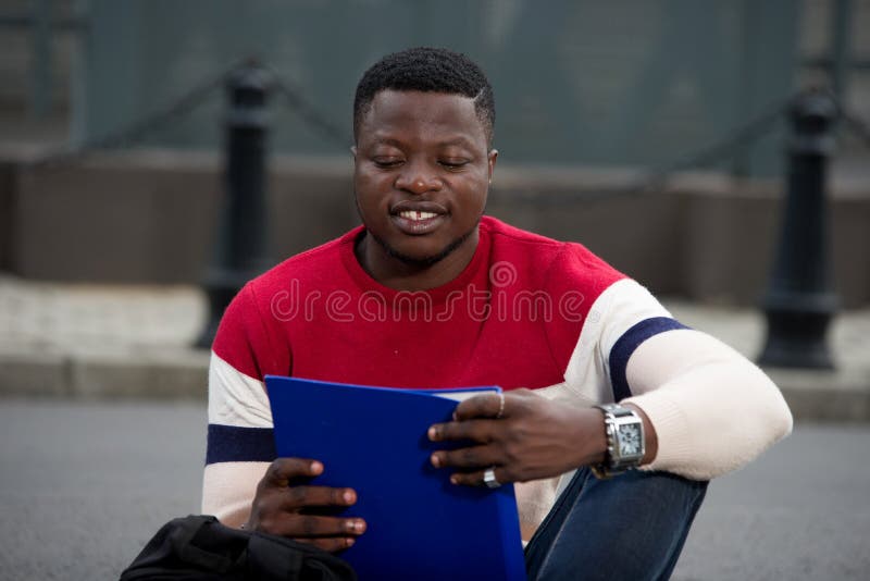 Handsome College Man Reading Notes in Notebook on Campus Stock Photo ...