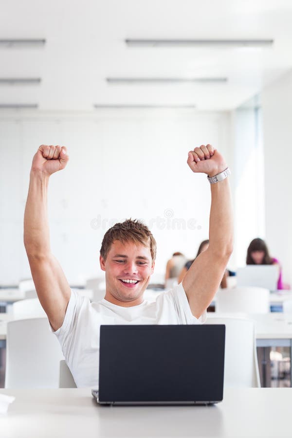Handsome College Student with Laptop Computer in University Library ...