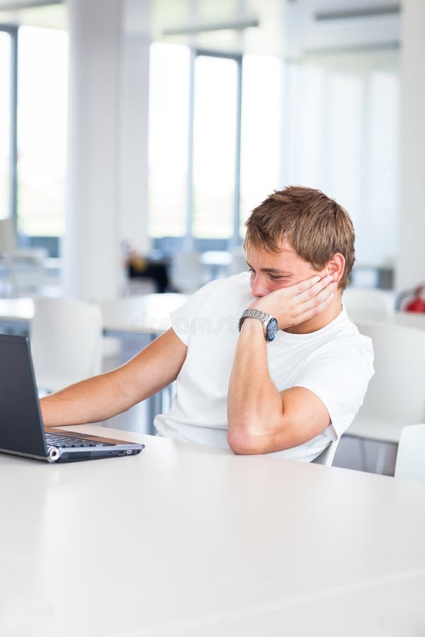 Handsome College Student with Laptop Computer in University Library ...