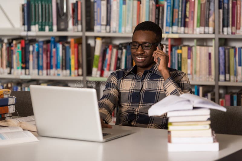 Handsome College Student Using Mobile Phone in Library Stock Photo ...