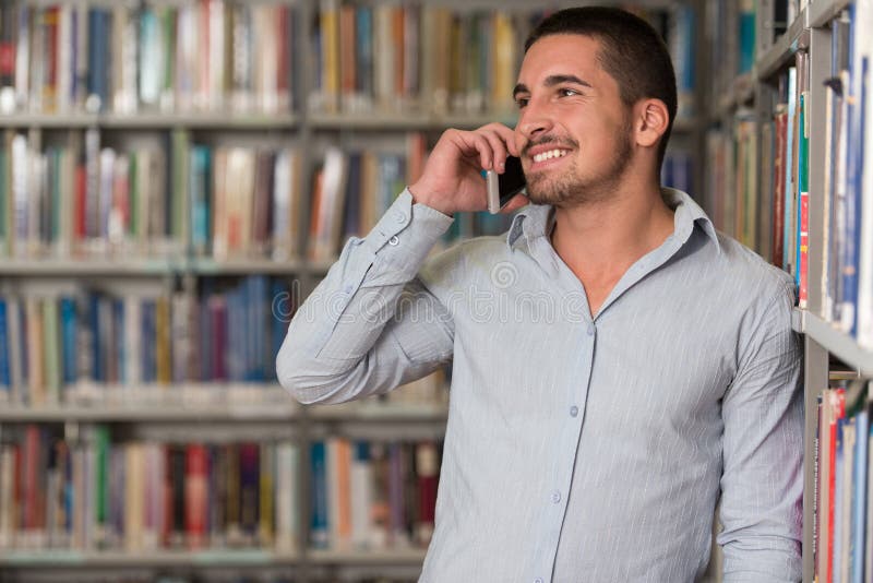 Handsome College Student Using Mobile Phone in Library Stock Image ...