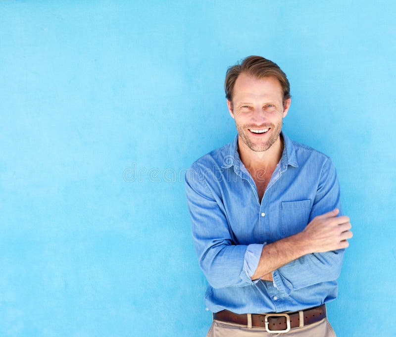 Handsome Confident Man Smiling Against Blue Wall Stock Image - Image of ...