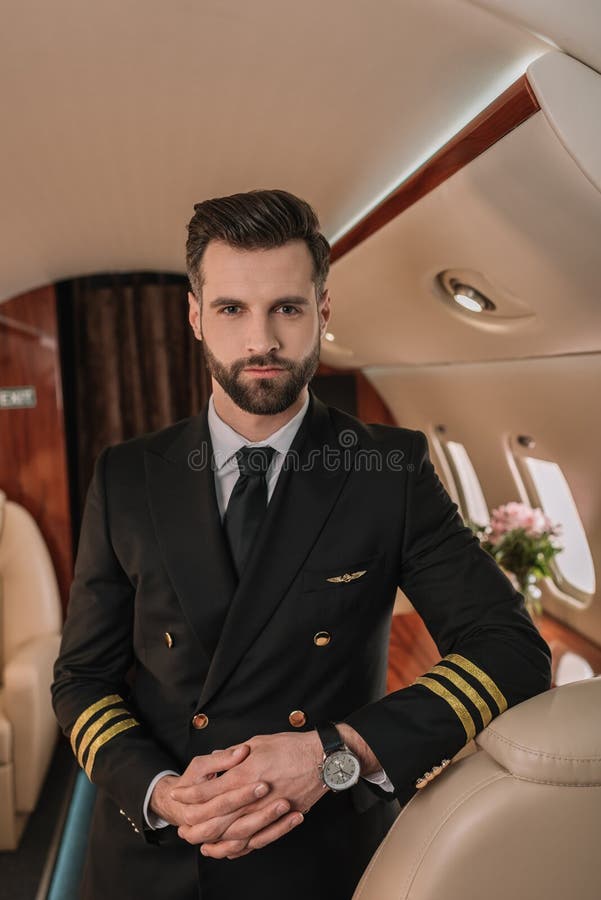 Confident Pilot Looking at Camera while Standing in Plane Stock Photo ...
