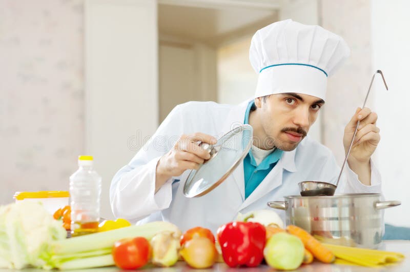 Handsome cook tasting soup stock photo. Image of occupation - 45395176