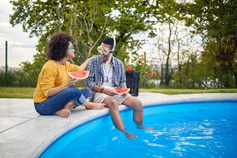Handsome Couple by the Pool Havin Fun, and Eating Watermelon Stock ...