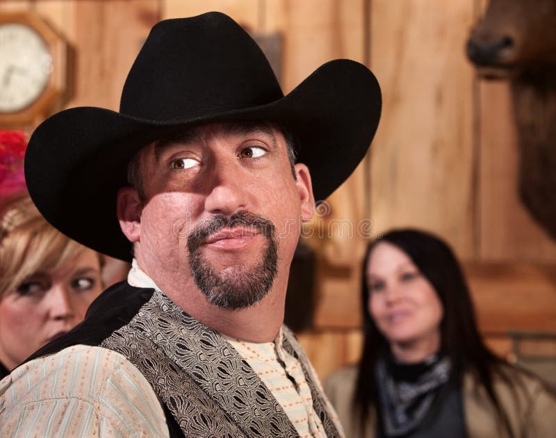 Handsome Cowboy Looks Back stock photo. Image of watching - 24882916