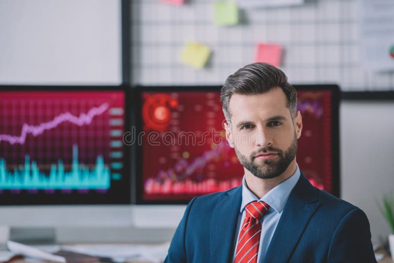 Handsome Data Analyst Looking at Camera Near Charts on Computer ...