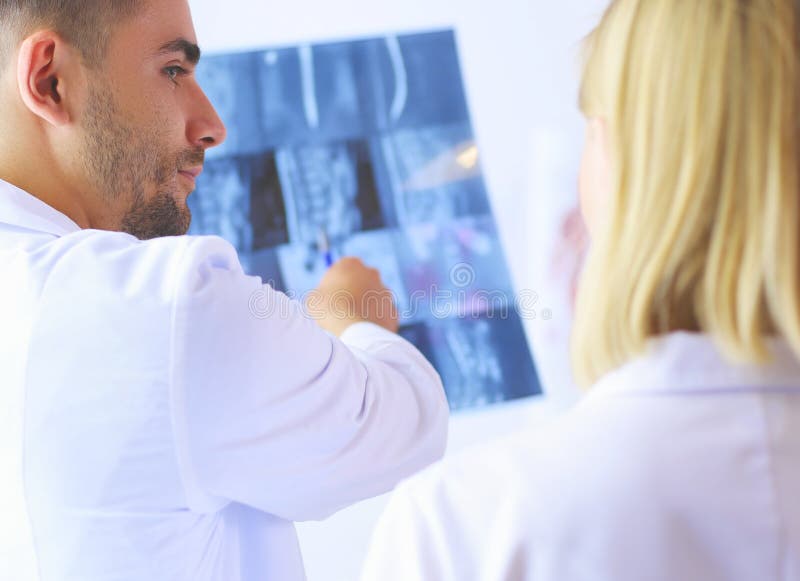 Handsome Doctor is Talking with Young Female Doctor and Making Notes ...