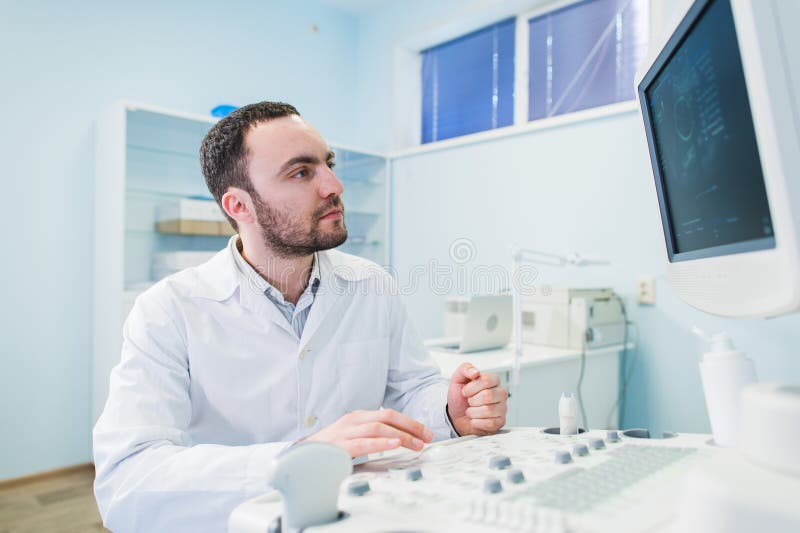 Handsome Doctor Using an Ultrasound Machine Stock Image - Image of ...
