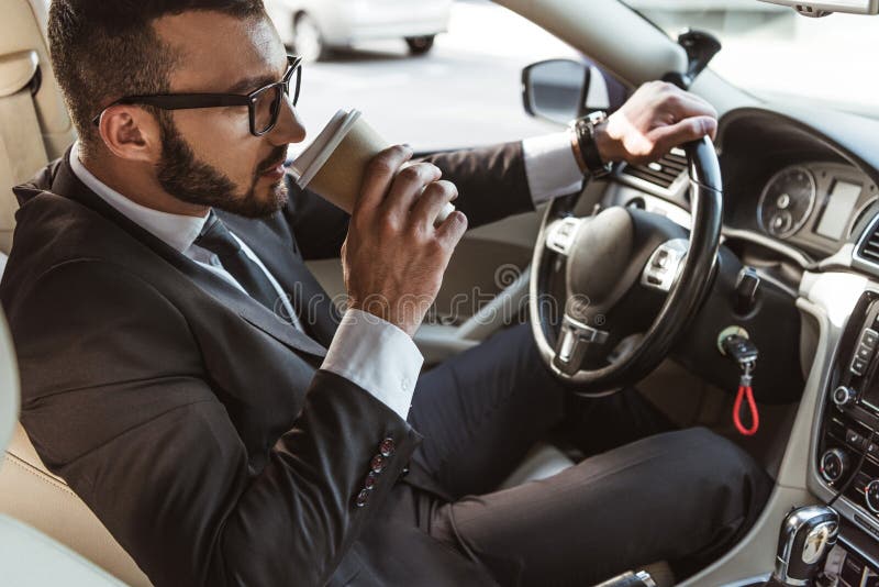 Handsome Driver in Suit Driving Car and Drinking Coffee Stock Image ...