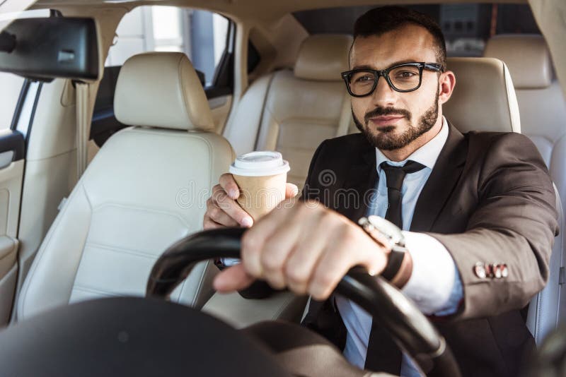 Handsome Driver in Suit Driving Car and Holding Coffee Stock Photo ...