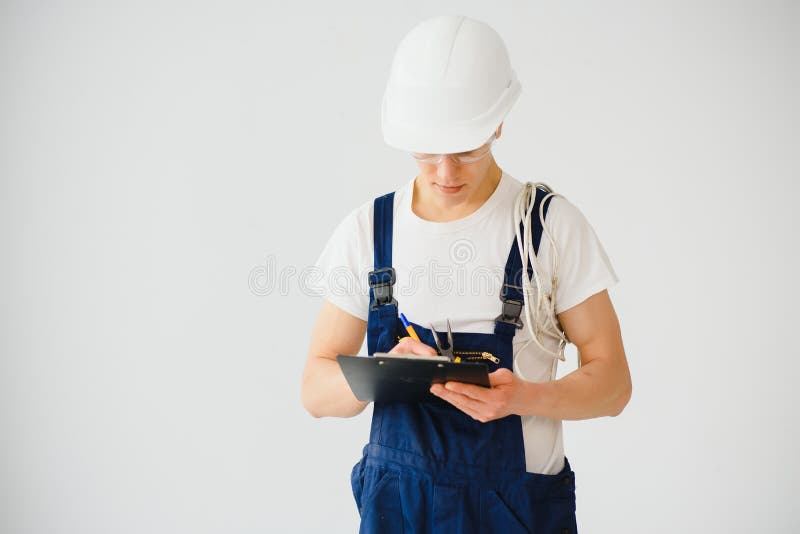 Handsome Electrical Engineer Holding Clipboard on White Background ...
