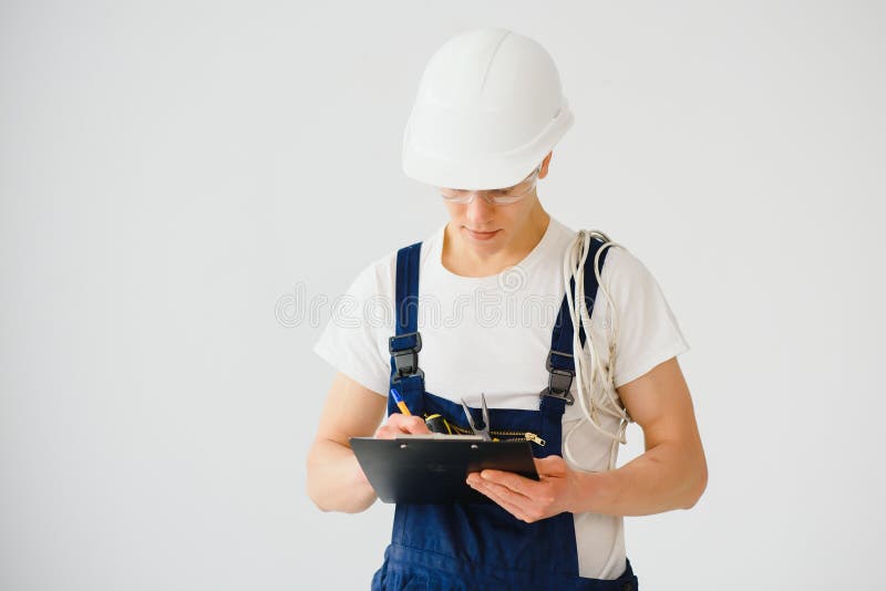 Handsome Electrical Engineer Holding Clipboard on White Background ...