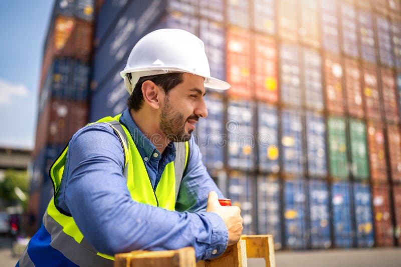 Handsome Engineer or Foreman Wears PPE Checking Container Storage with ...