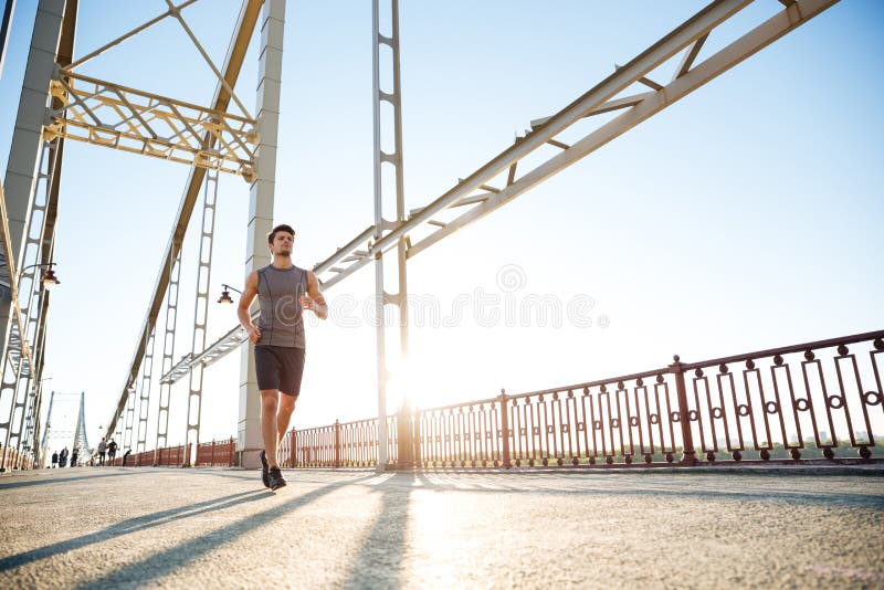 Handsome Fit Man Running Fast Along Big Modern Bridge Stock Image ...
