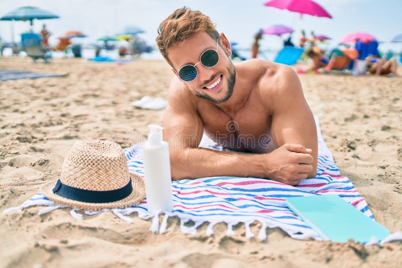Handsome Fitness Caucasian Man At The Beach On A Sunny Day Sunbathing