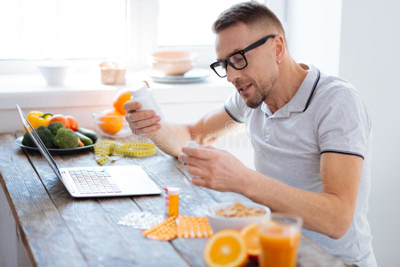 Handsome Focused Man Examining Biohacking Supplements Stock Photo ...
