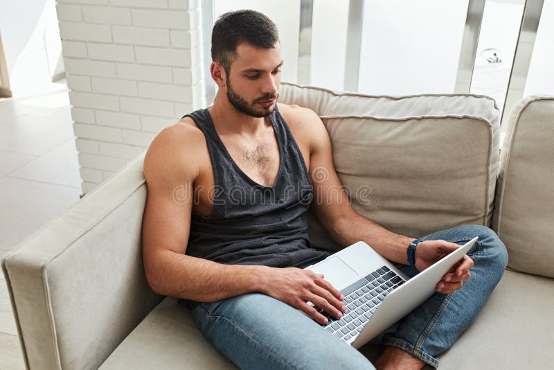 Serious Young Man Working on Laptop at Home Stock Photo - Image of ...