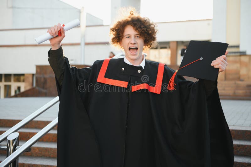 Handsome Graduate in Graduation Glow with Diploma. Stock Photo - Image ...
