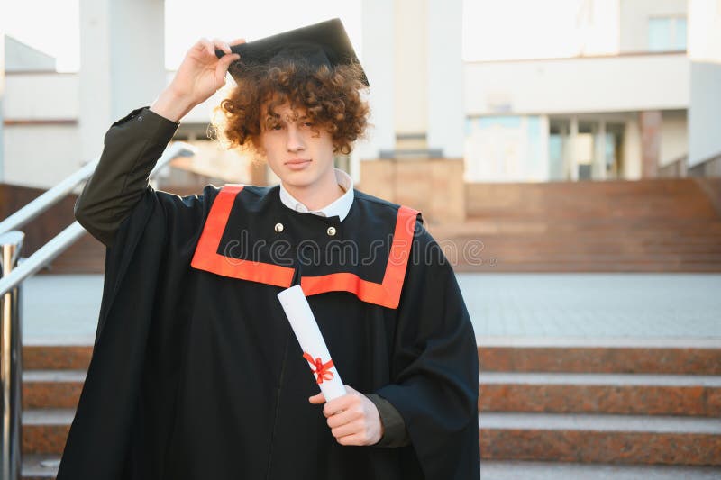 Handsome Graduate in Graduation Glow with Diploma. Stock Photo - Image ...