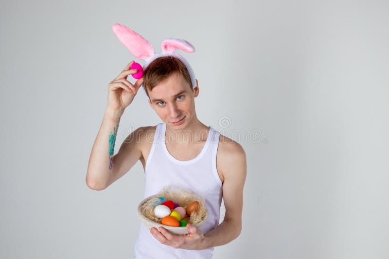 Handsome Guy with Bunny Ears Holding Basket with Eggs. Happy Easter ...