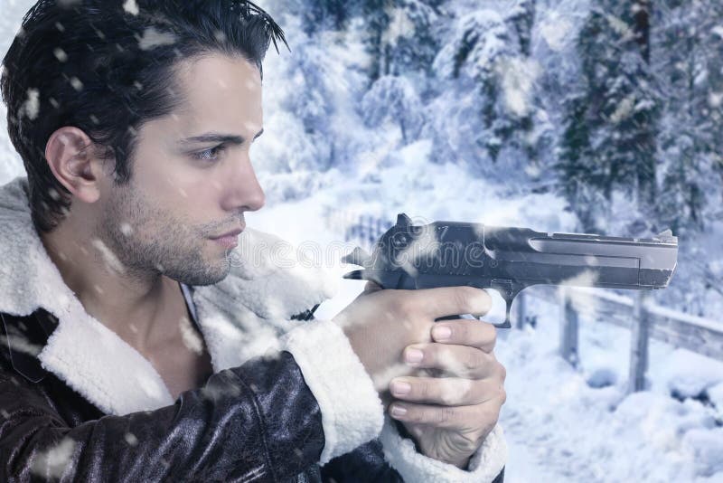 Handsome guy holding a gun stock photo. Image of snow - 60886128