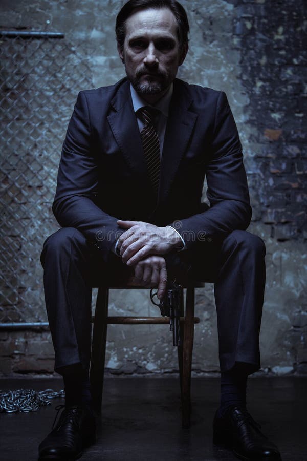 Charming Villain Sitting in Dark Room Stock Image - Image of close ...