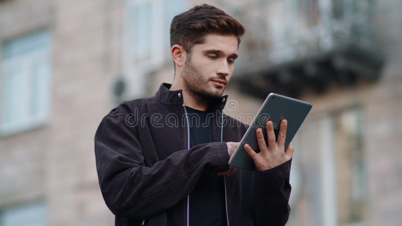 Handsome Guy Looking Tablet Screen Outdoors. Young Man Touching Digital ...