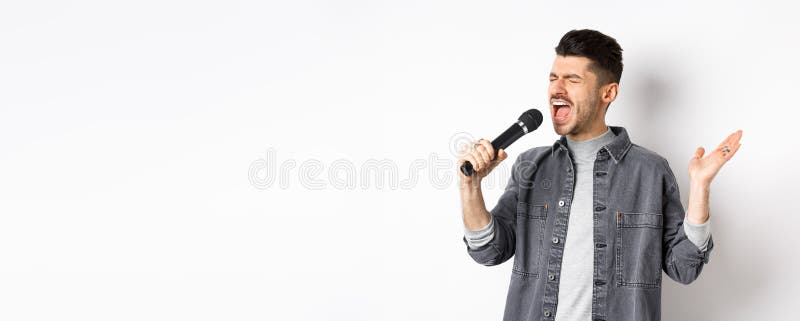 Handsome Guy Singing in Mic with Passion, Perform for Audience, Holding ...