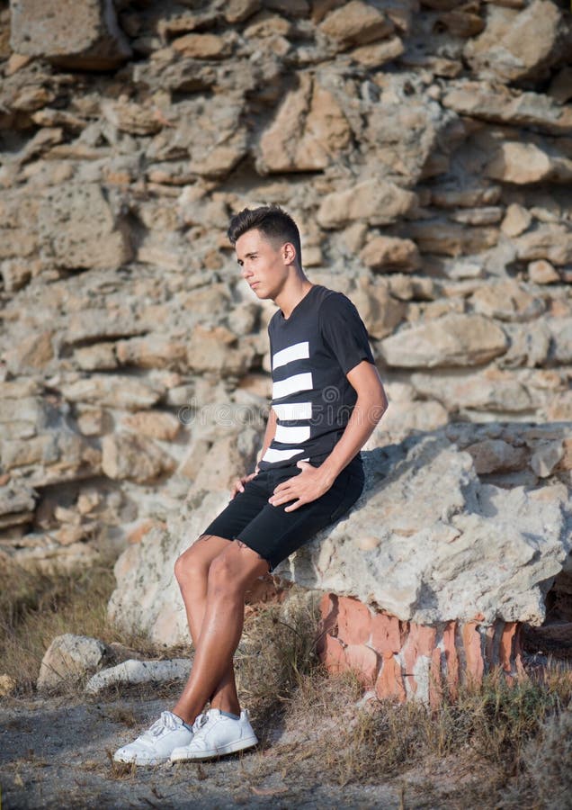 Handsome Guy Sits on the Rocks Stock Photo - Image of cute, rock: 98436412