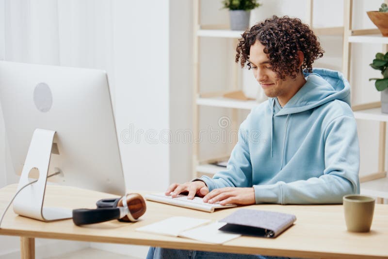 Handsome Guy Sitting at a Table in Front of a Computer Freelance ...
