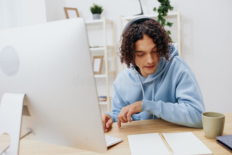 Handsome Guy Sitting at a Table in Front of a Computer Music Lifestyle ...