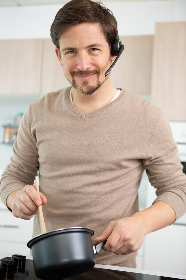 Handsome Guy Talking on Mobile Phone while Cooking Stock Photo - Image ...