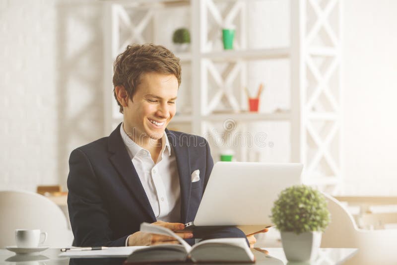 Handsome guy using laptop stock photo. Image of education - 94098168
