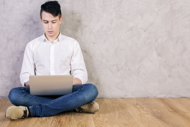 Handsome guy using laptop stock image. Image of apartment - 72196339