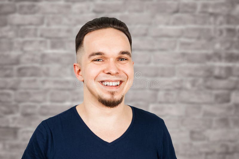 Handsome Guy with a Wide White Smile and Even Teeth on Brick Wall ...